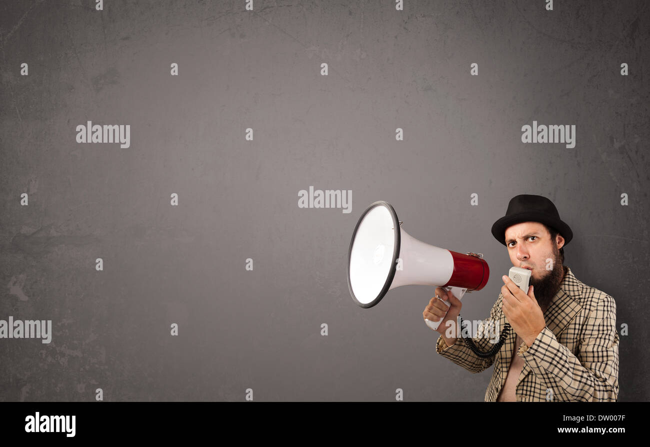 Guy shouting into megaphone on copy space background Stock Photo - Alamy