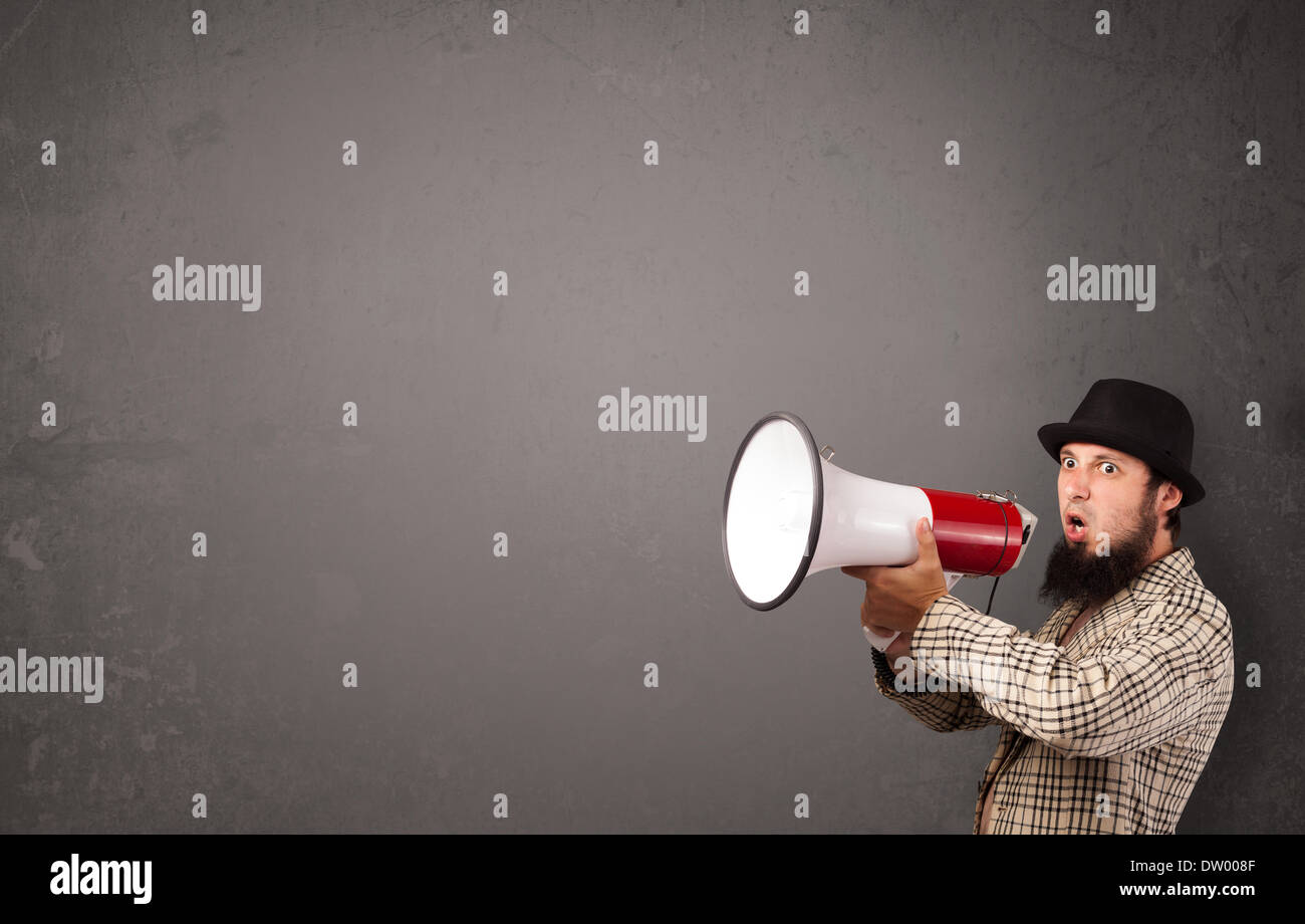 Guy shouting into megaphone on copy space background Stock Photo - Alamy