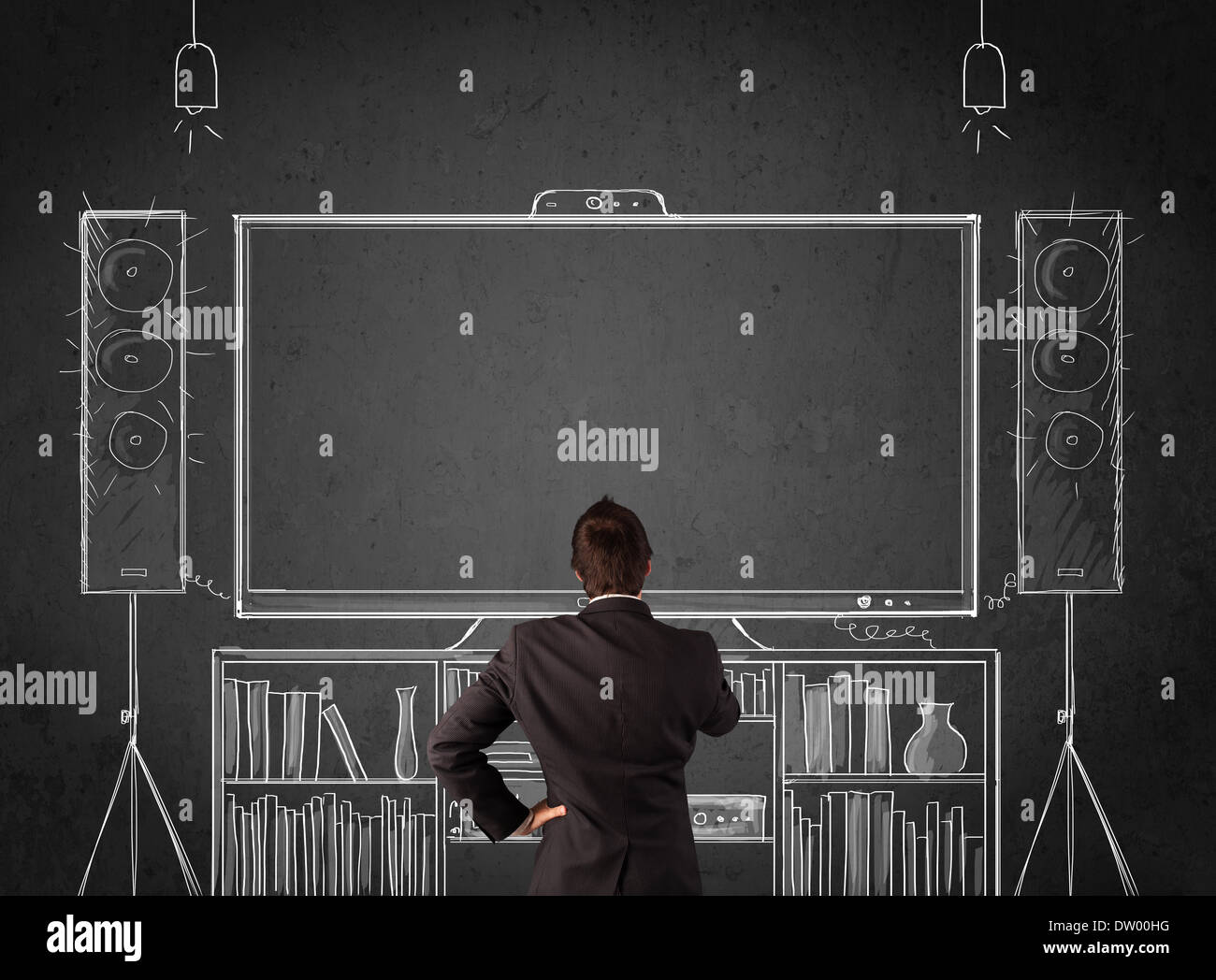 Businessman in front of a home cinema system Stock Photo - Alamy