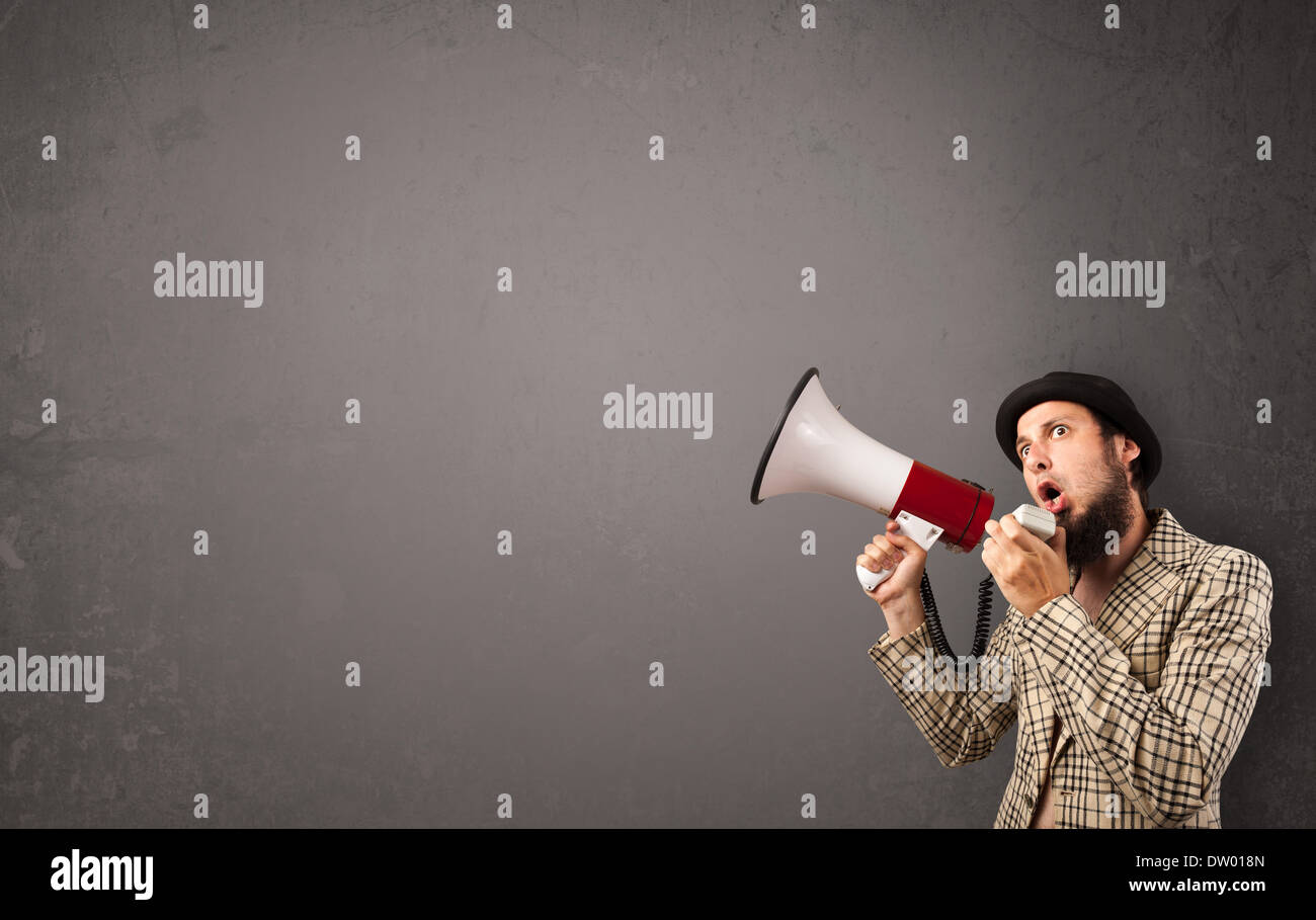 Guy shouting into megaphone on copy space background Stock Photo - Alamy