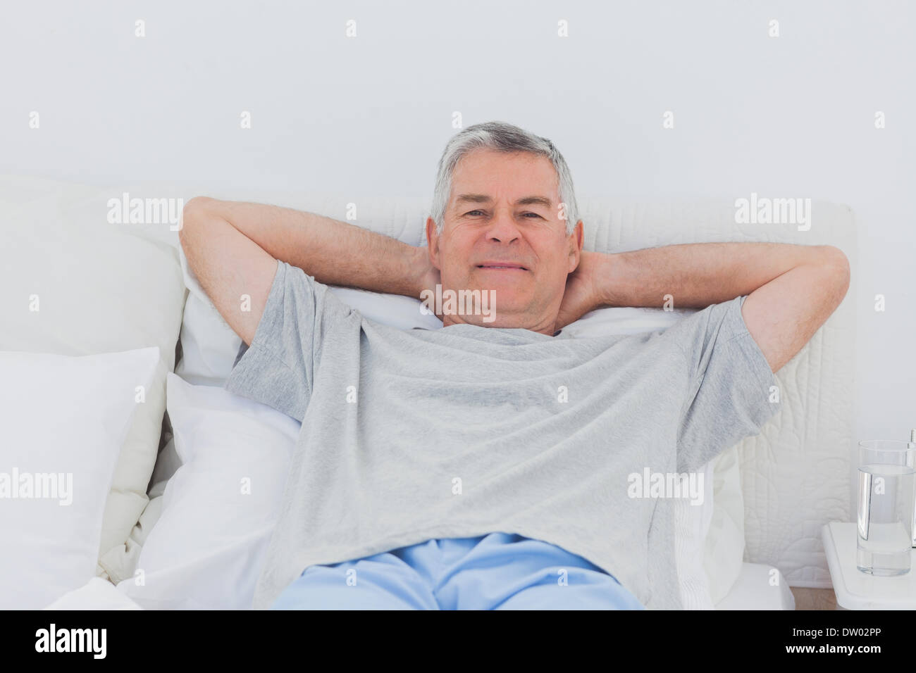 Man relaxing in bed Stock Photo - Alamy