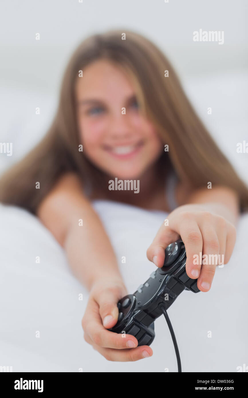 Portrait of a cute girl playing video games Stock Photo - Alamy