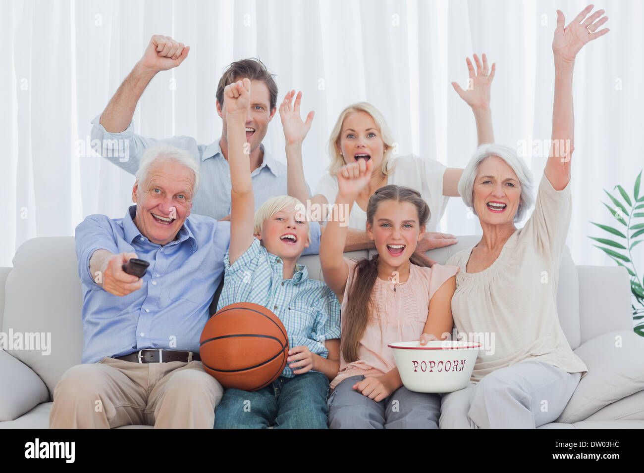 Extended family watching the tv Stock Photo - Alamy