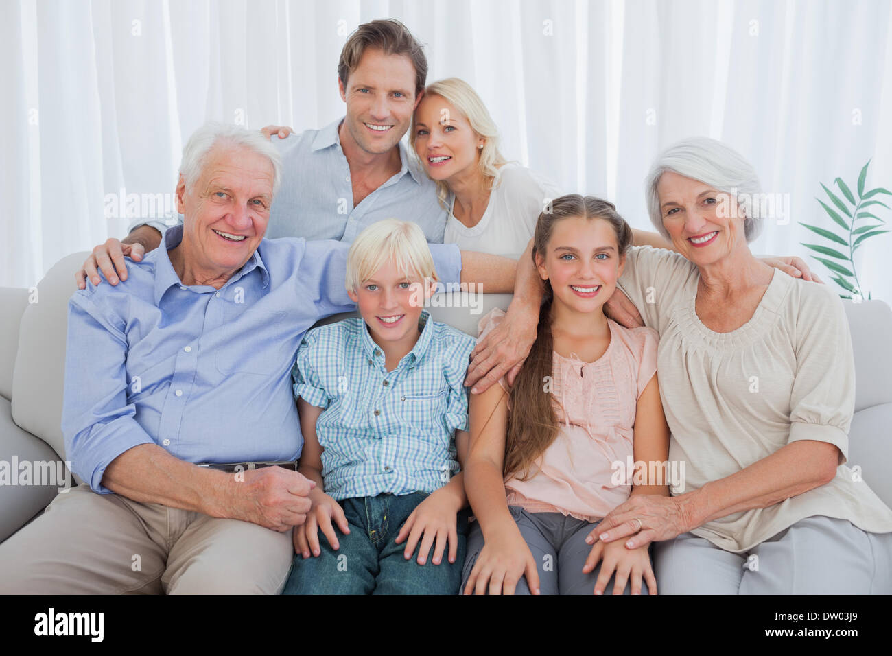 Extended family smiling at camera Stock Photo - Alamy