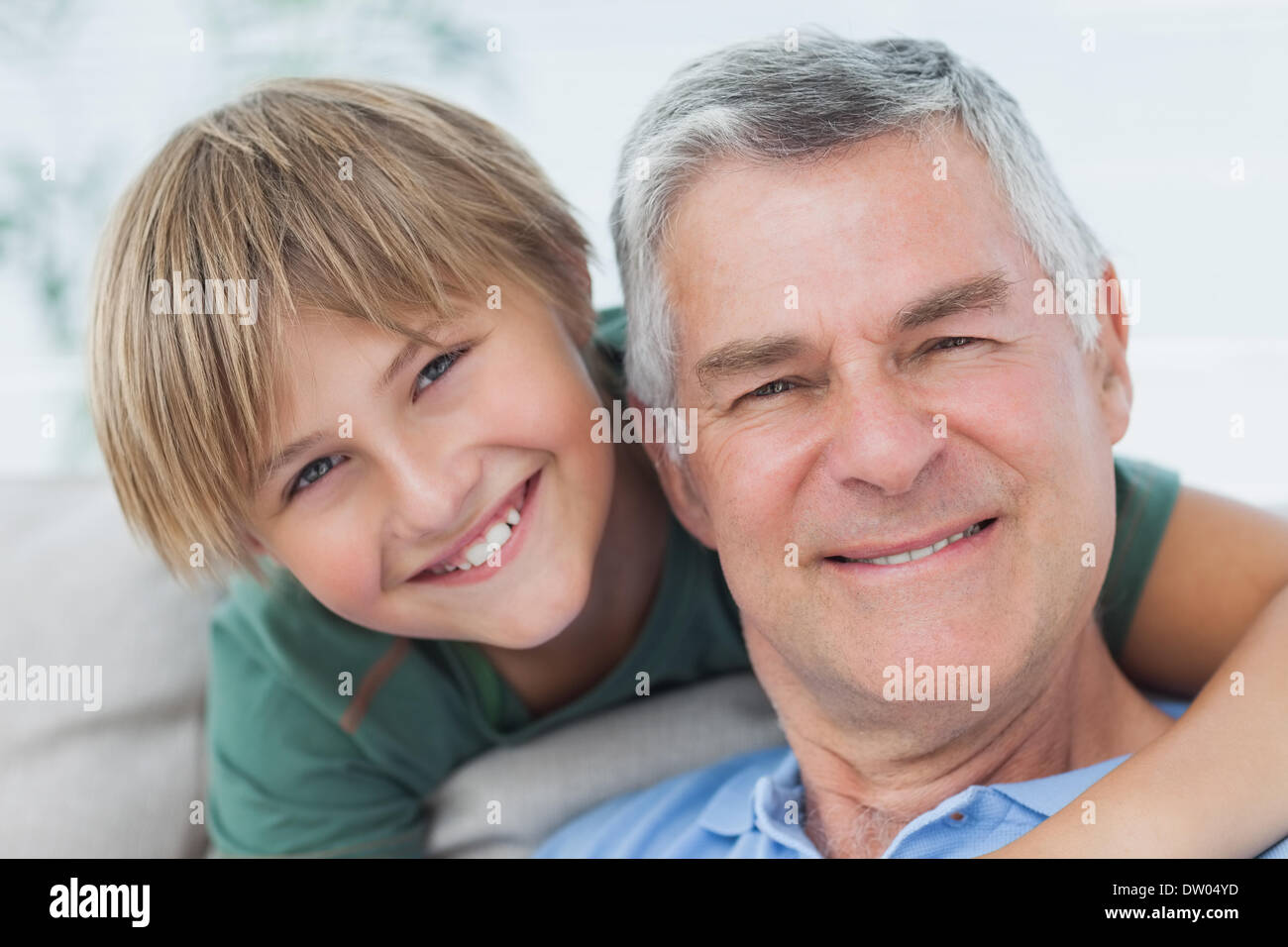 Portrait of grandson hugging grandfather Stock Photo - Alamy