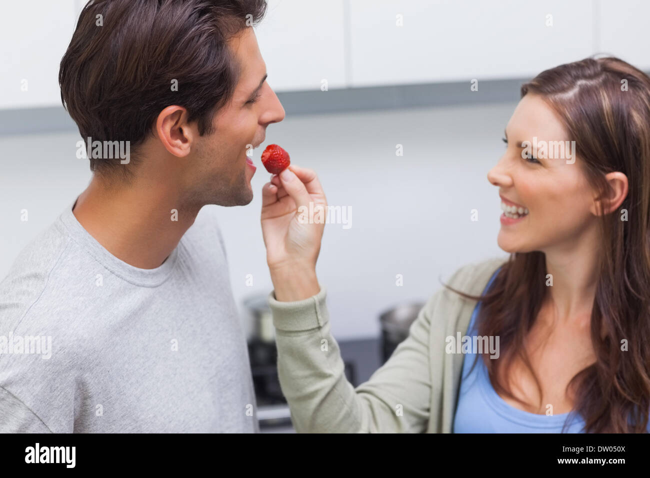 Woman feeding her husband cherry tomato Stock Photo - Alamy