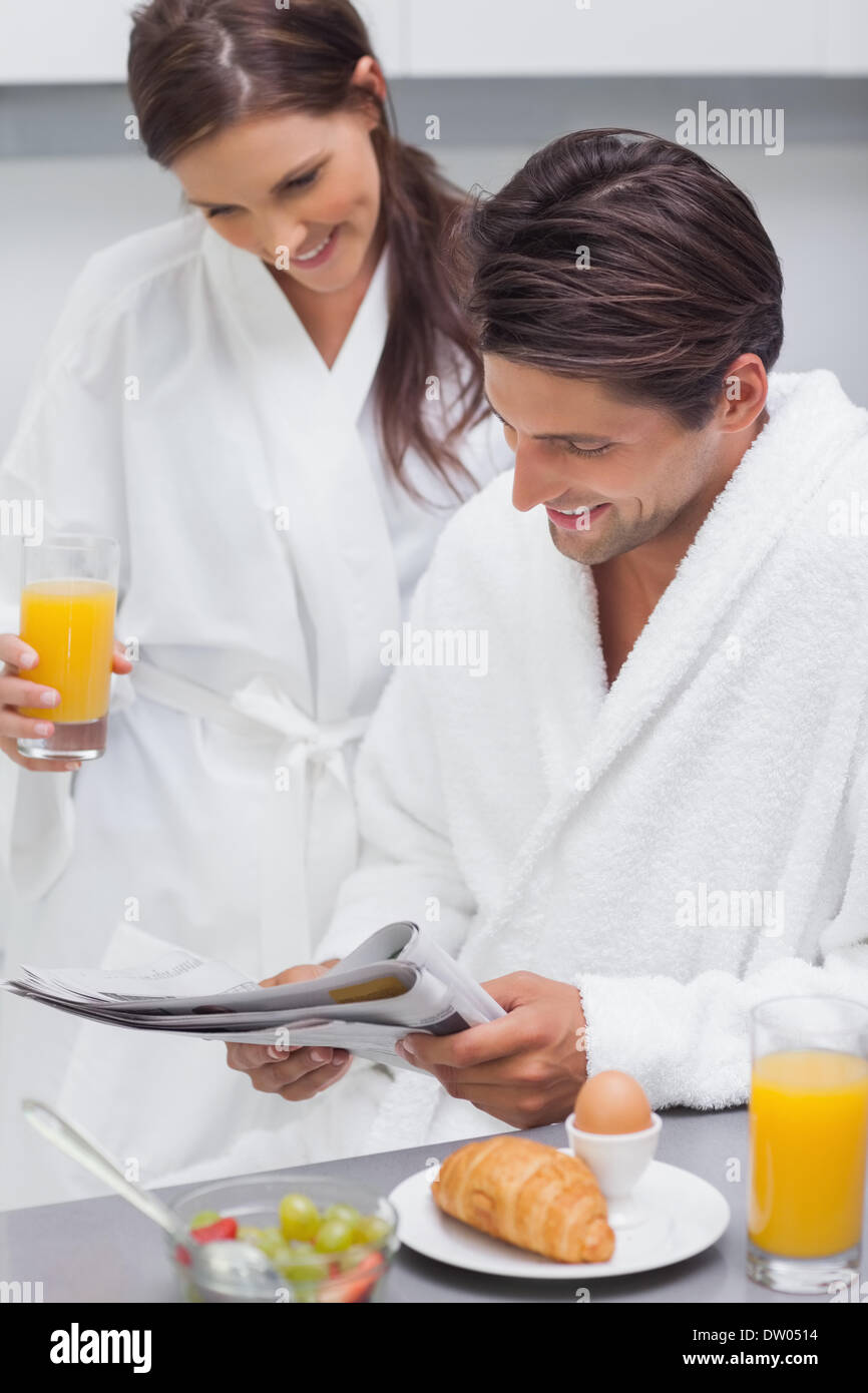 Couple having breakfast in the kitchen Stock Photo - Alamy