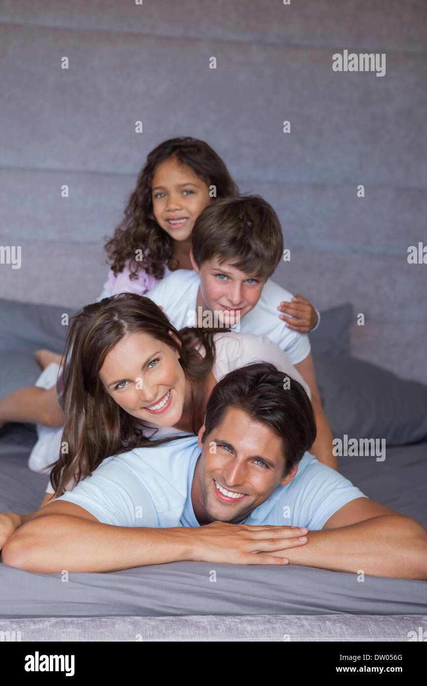 Happy family playing together on the bed Stock Photo - Alamy