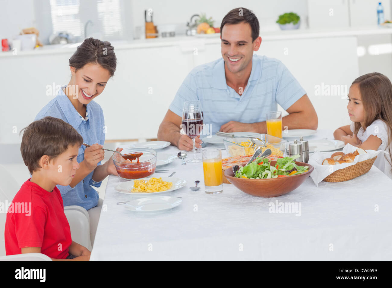 Family eating pasta and salad Stock Photo - Alamy