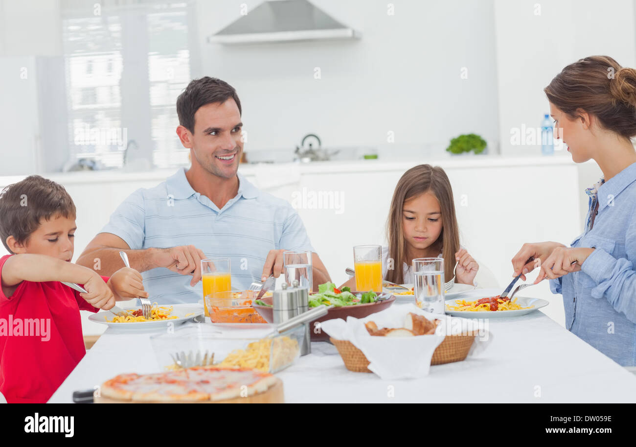 Family eating pasta with sauce Stock Photo - Alamy