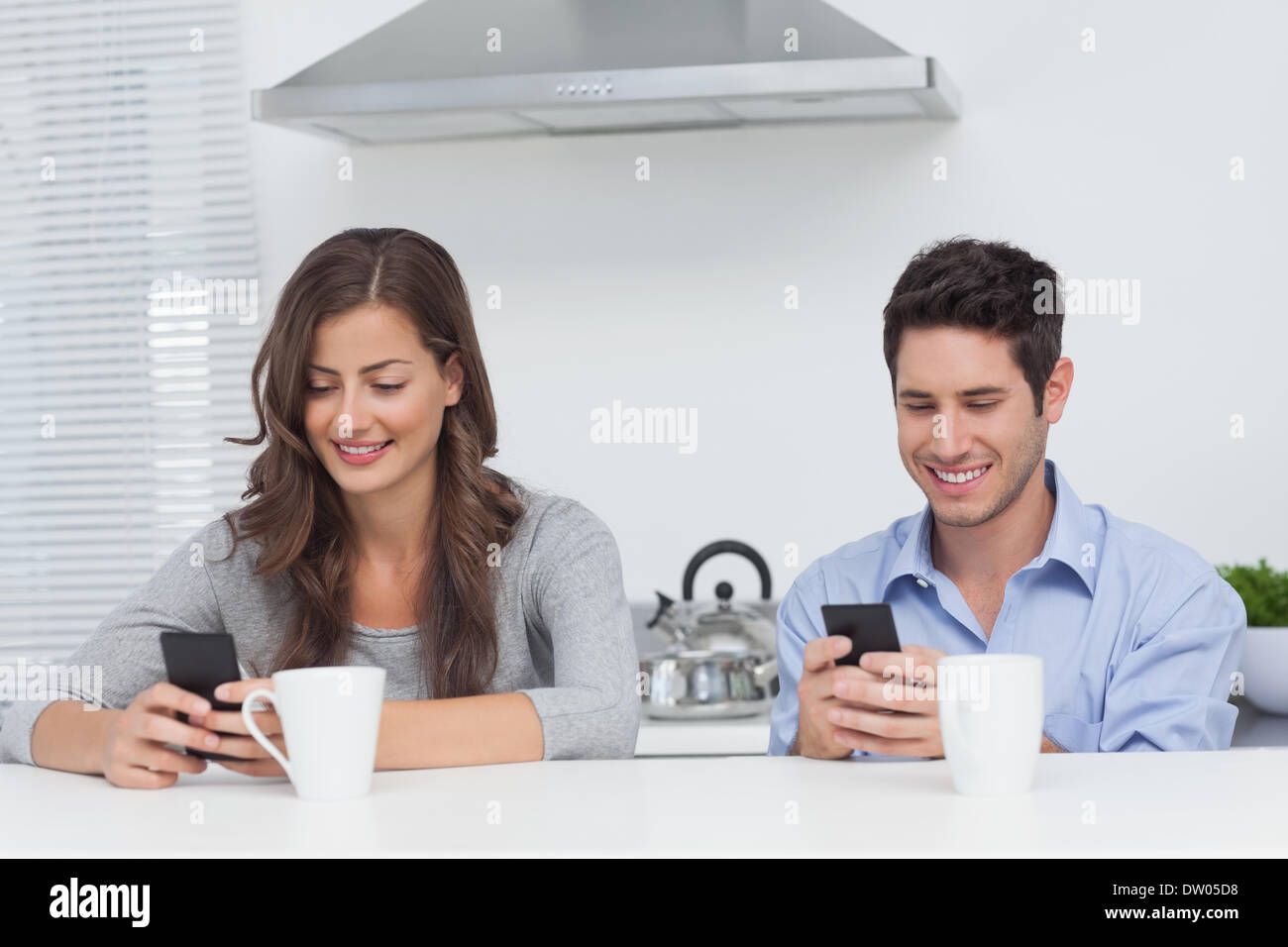 Couple using their smartphones Stock Photo - Alamy