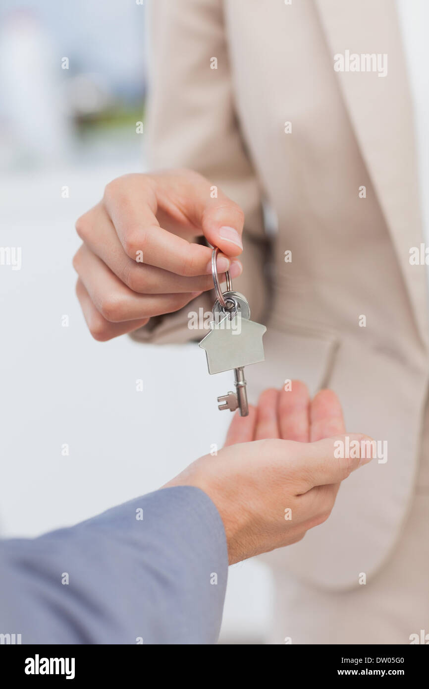 Estate agent giving house key Stock Photo - Alamy