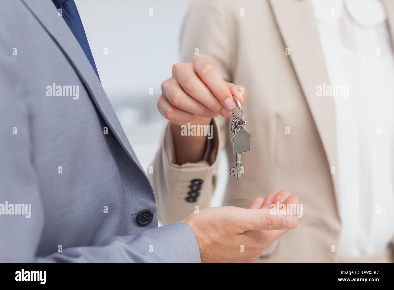 Real estate agent giving house key Stock Photo - Alamy