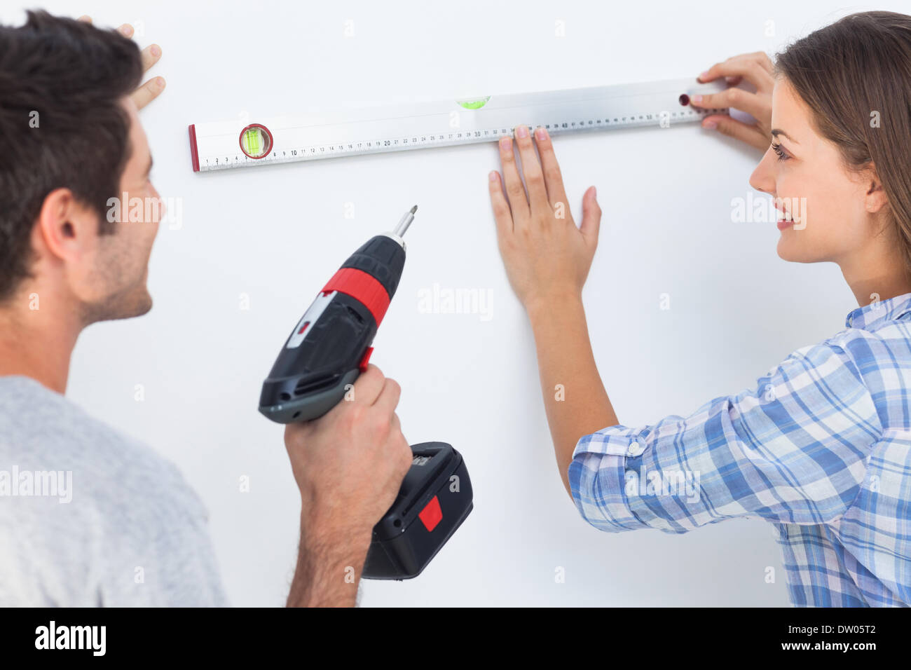 Happy man and his wife measuring together Stock Photo - Alamy