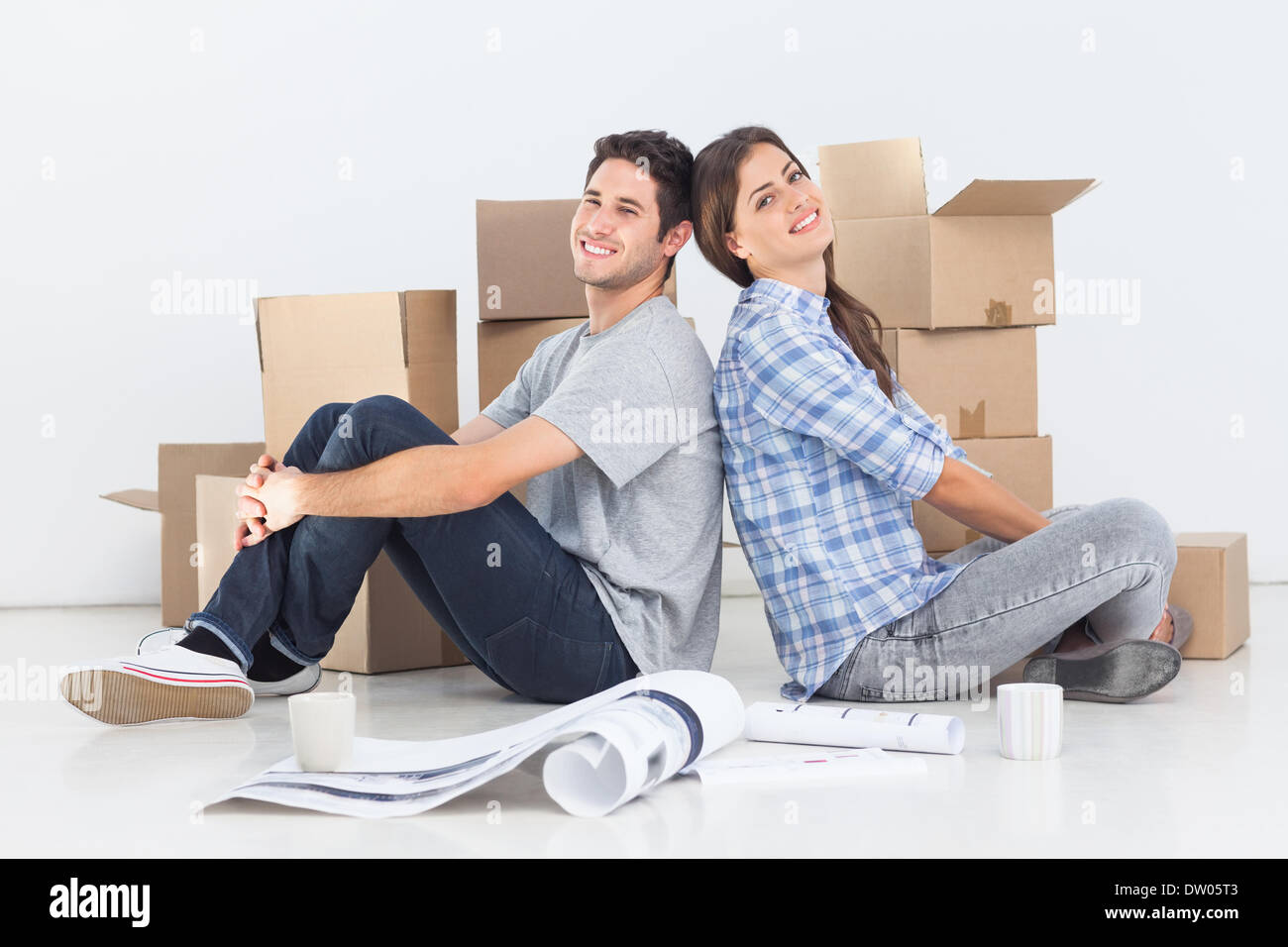 Couple sitting back to back Stock Photo - Alamy