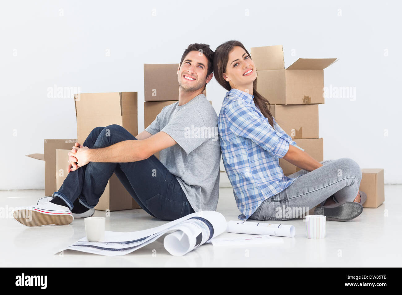 Beautiful couple sitting back to back Stock Photo - Alamy