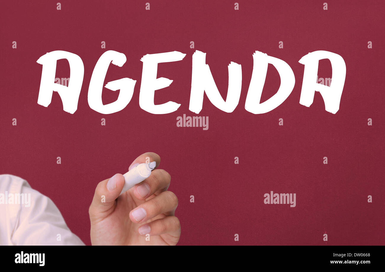 Businessman writing the word agenda Stock Photo - Alamy