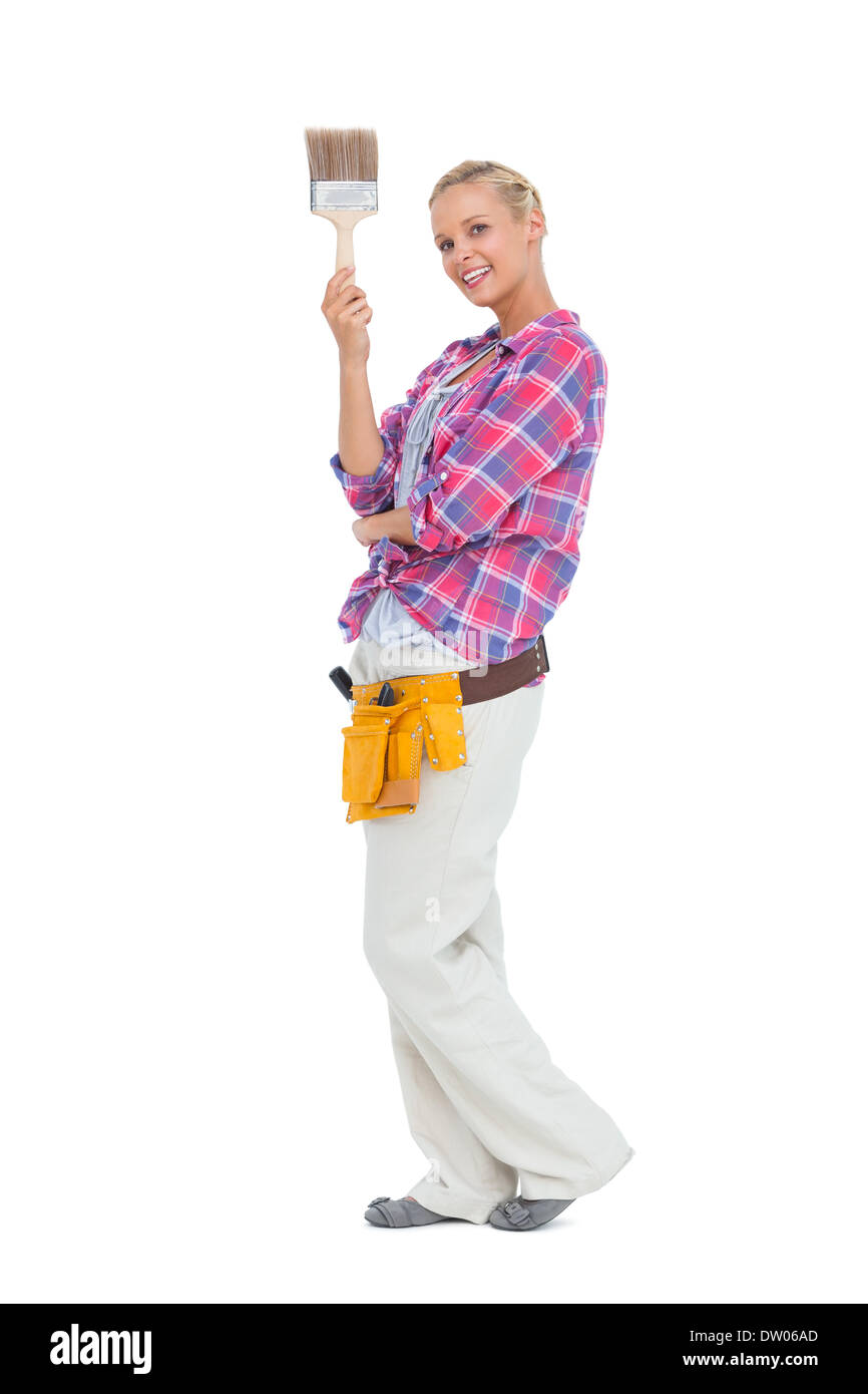 Blonde standing holding paint brush Stock Photo - Alamy