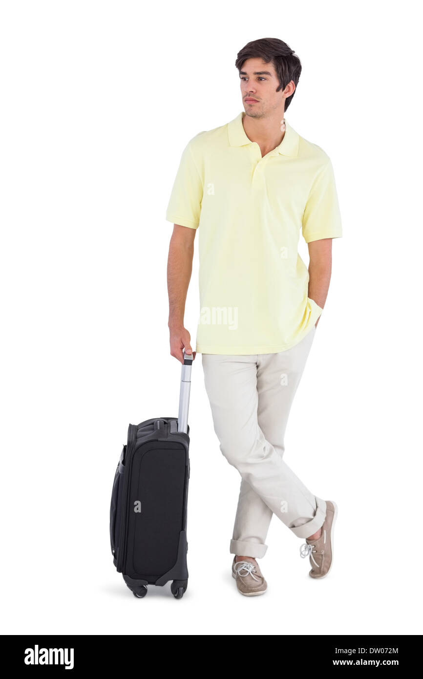 Thoughtful man standing with his suitcase Stock Photo - Alamy