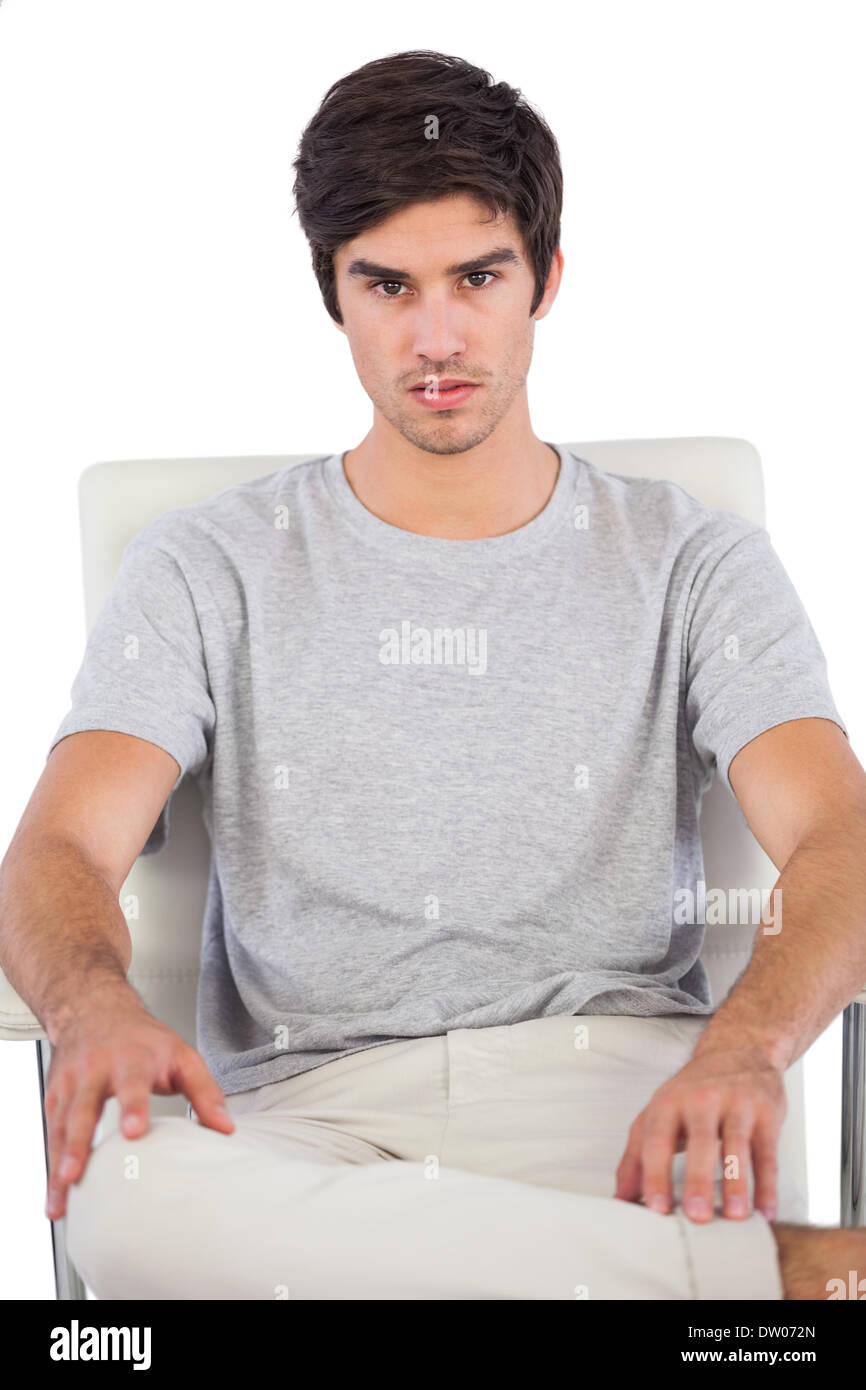 Serious man sitting on a office chair Stock Photo - Alamy