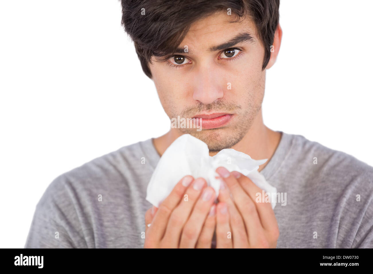 Young man using handkerchief Stock Photo - Alamy