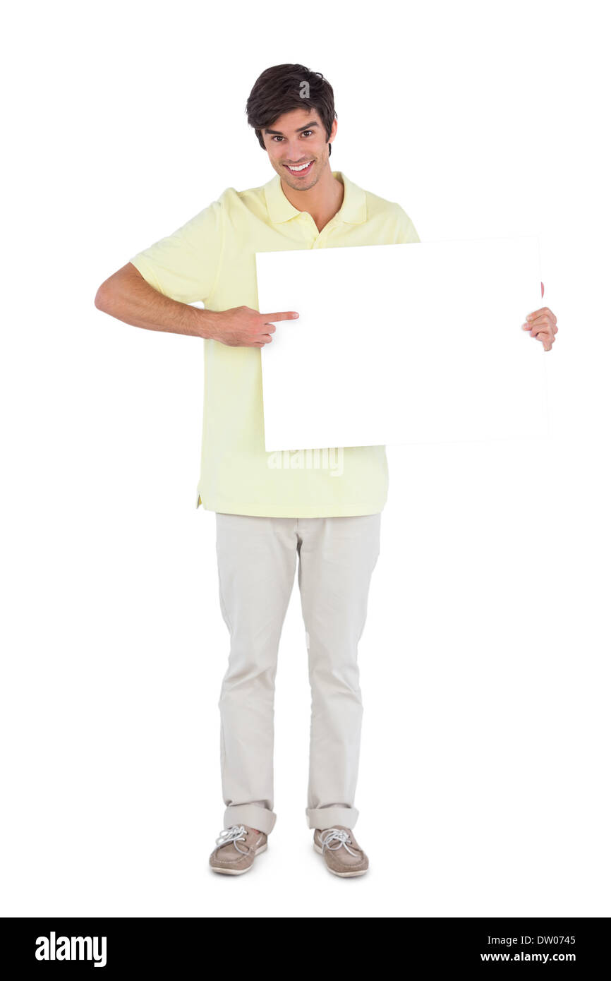 Smiling man pointing something on empty sign Stock Photo - Alamy