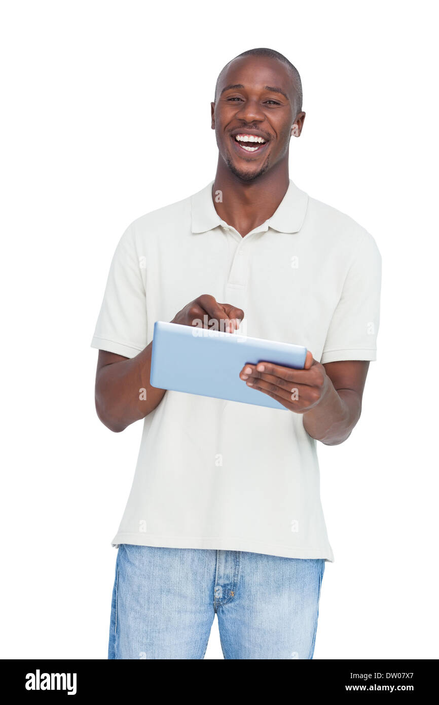 Laughing man using tablet pc Stock Photo - Alamy