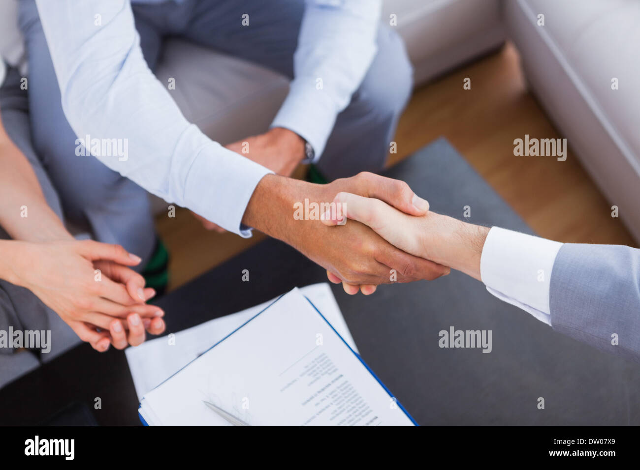 Salesman shaking hands with client Stock Photo - Alamy