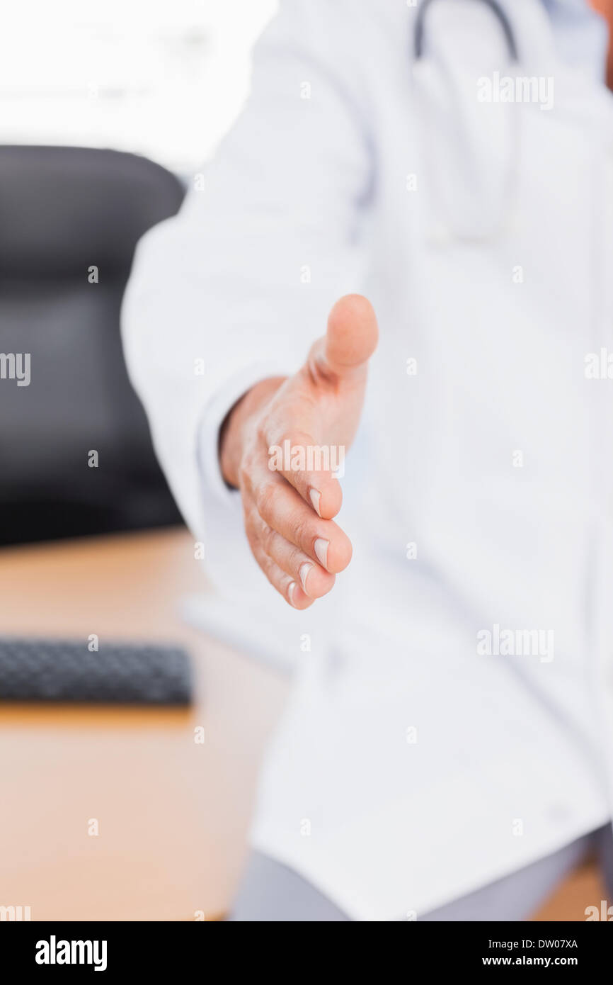 Doctor holding out his hand for a handshake Stock Photo - Alamy
