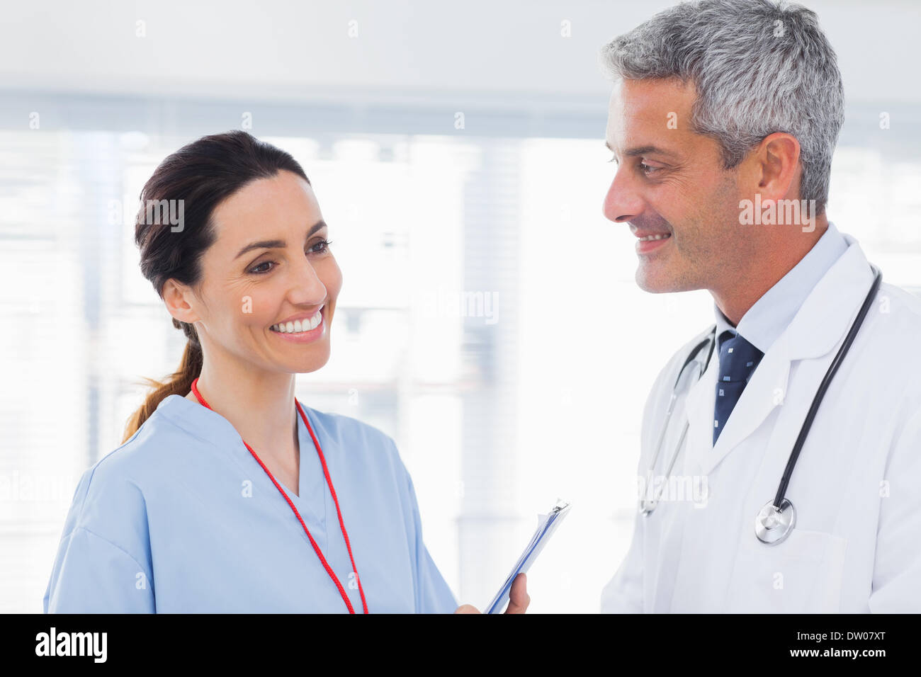 Nurse talking with doctor Stock Photo - Alamy
