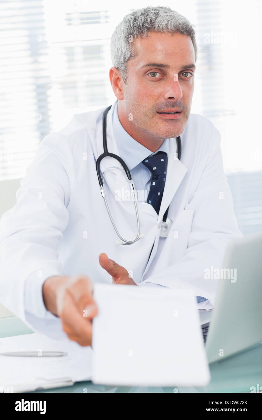 Doctor giving prescription to camera Stock Photo - Alamy