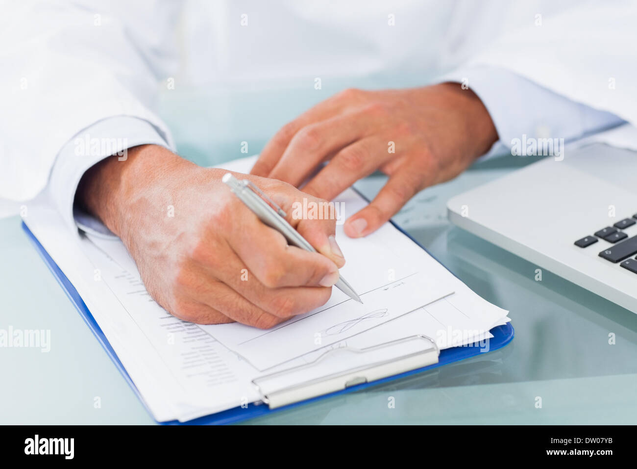 Doctor hand writing prescription on hi-res stock photography and images ...