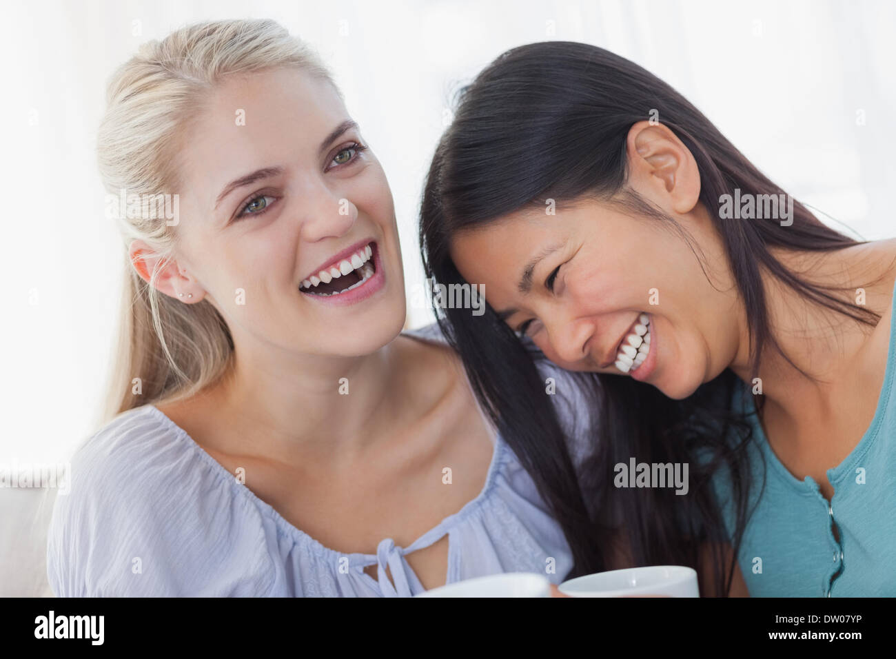 Friends drinking coffee together and laughing Stock Photo - Alamy
