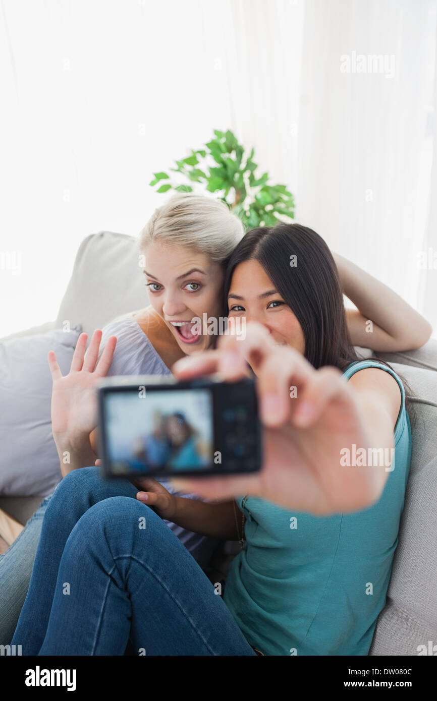 Two silly friends taking photo with camera Stock Photo - Alamy