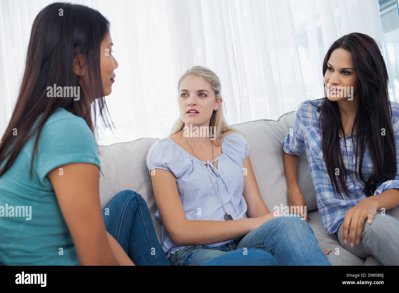 Friends having a conversation together Stock Photo - Alamy