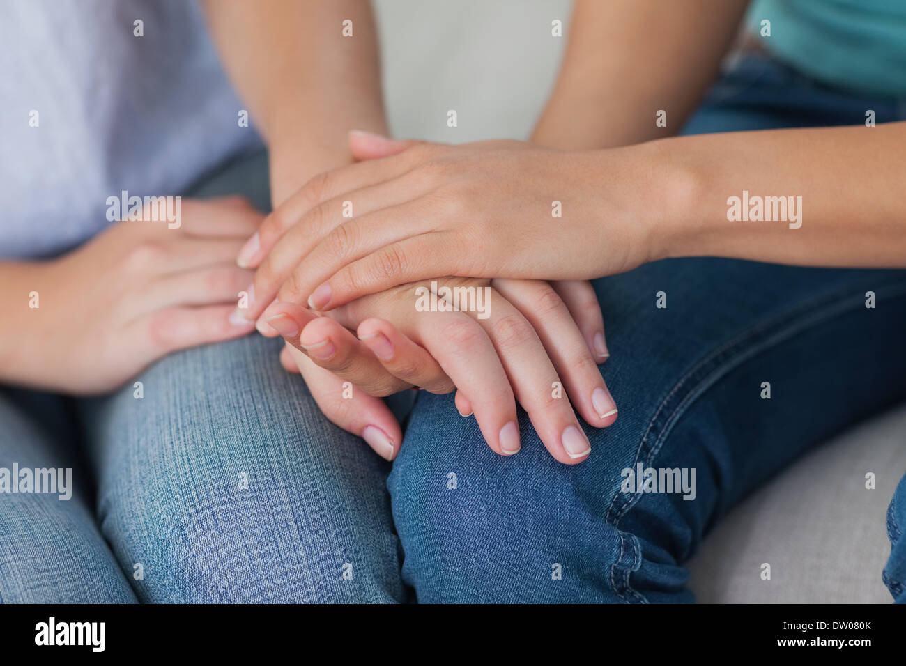 Close friends touching hands Stock Photo - Alamy