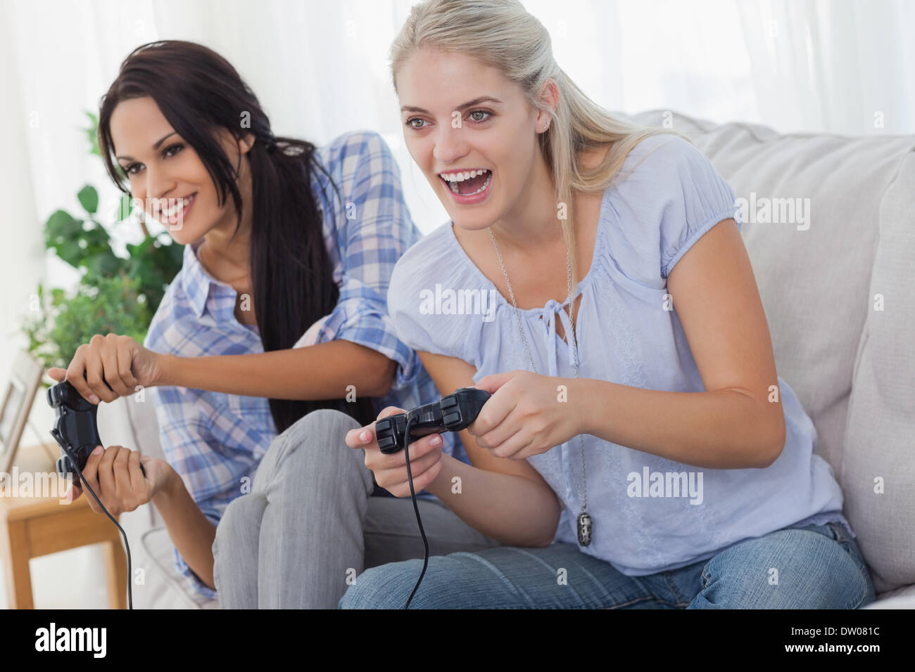Friends playing video games and having fun Stock Photo - Alamy