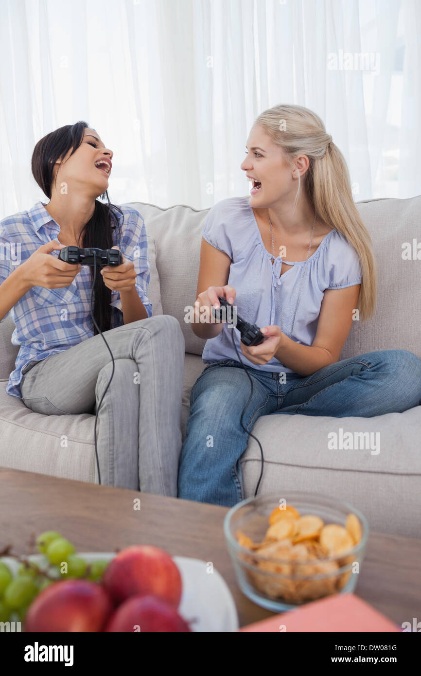 Happy friends playing video games Stock Photo - Alamy
