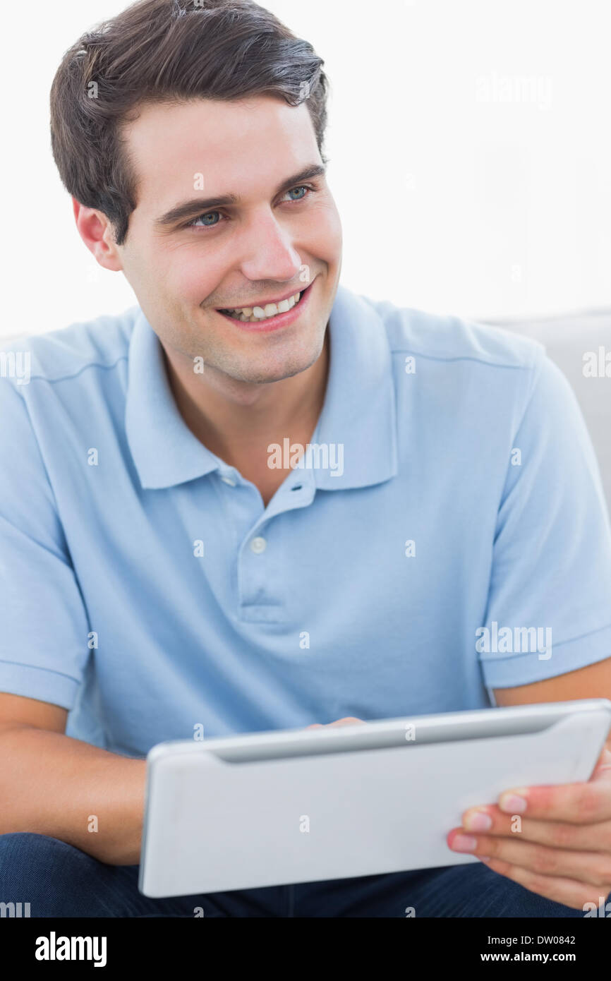 Smiling man using his tablet Stock Photo - Alamy