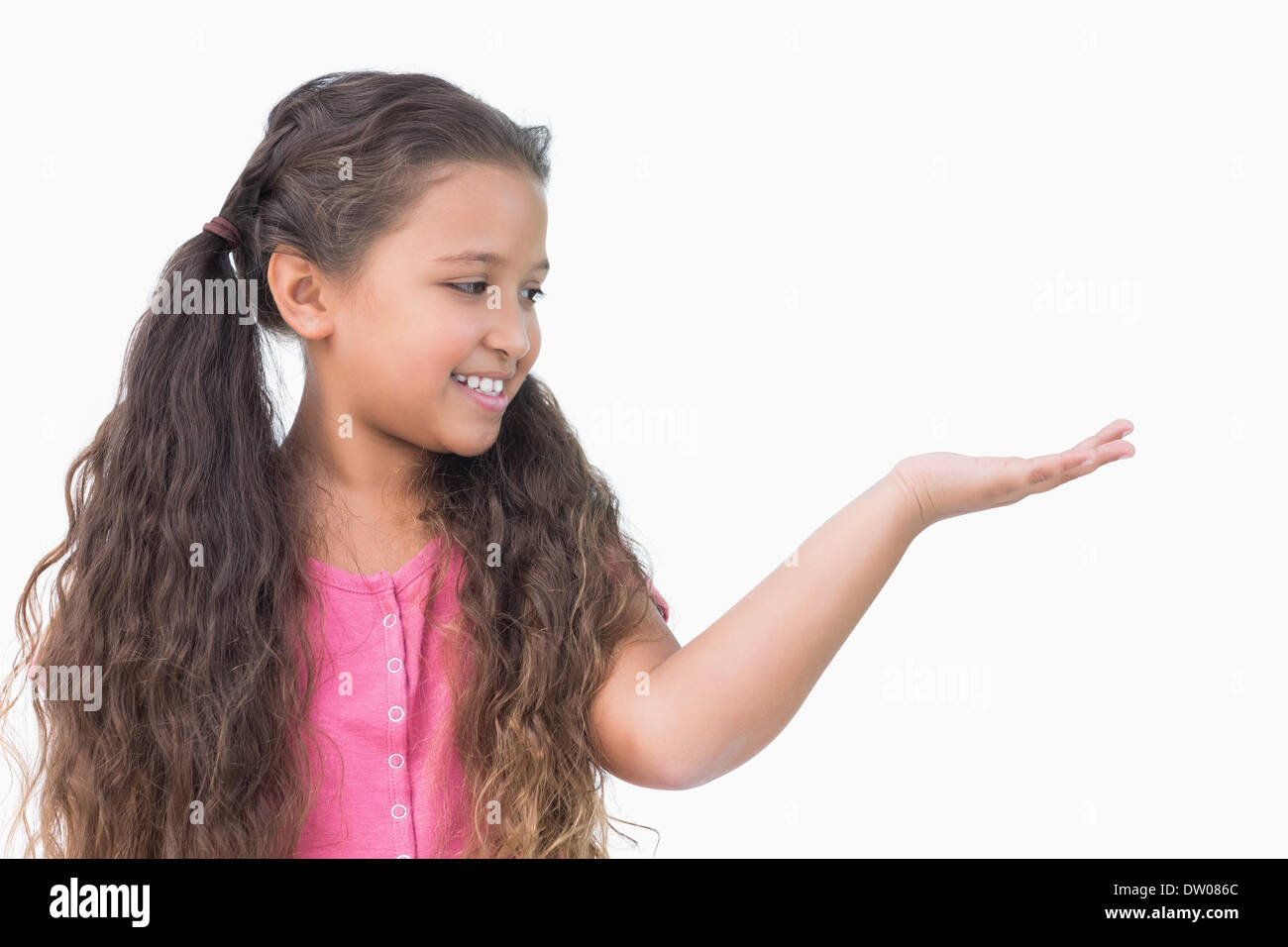 Smiling little girl presenting something Stock Photo - Alamy