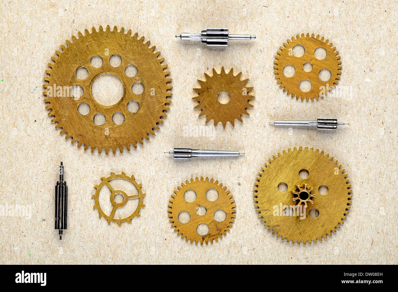 Old parts of clockwork on paper background Stock Photo - Alamy