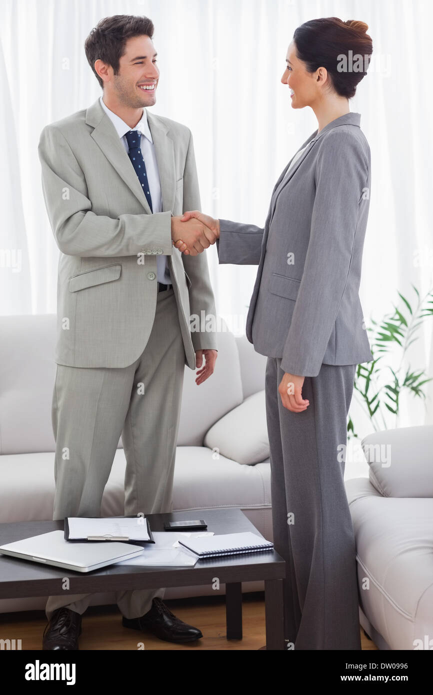 Colleagues having handshake during meeting Stock Photo - Alamy