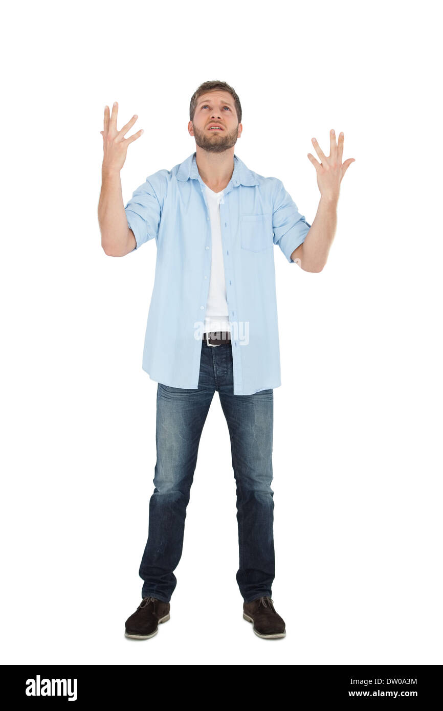 Handsome man posing with hands up Stock Photo - Alamy