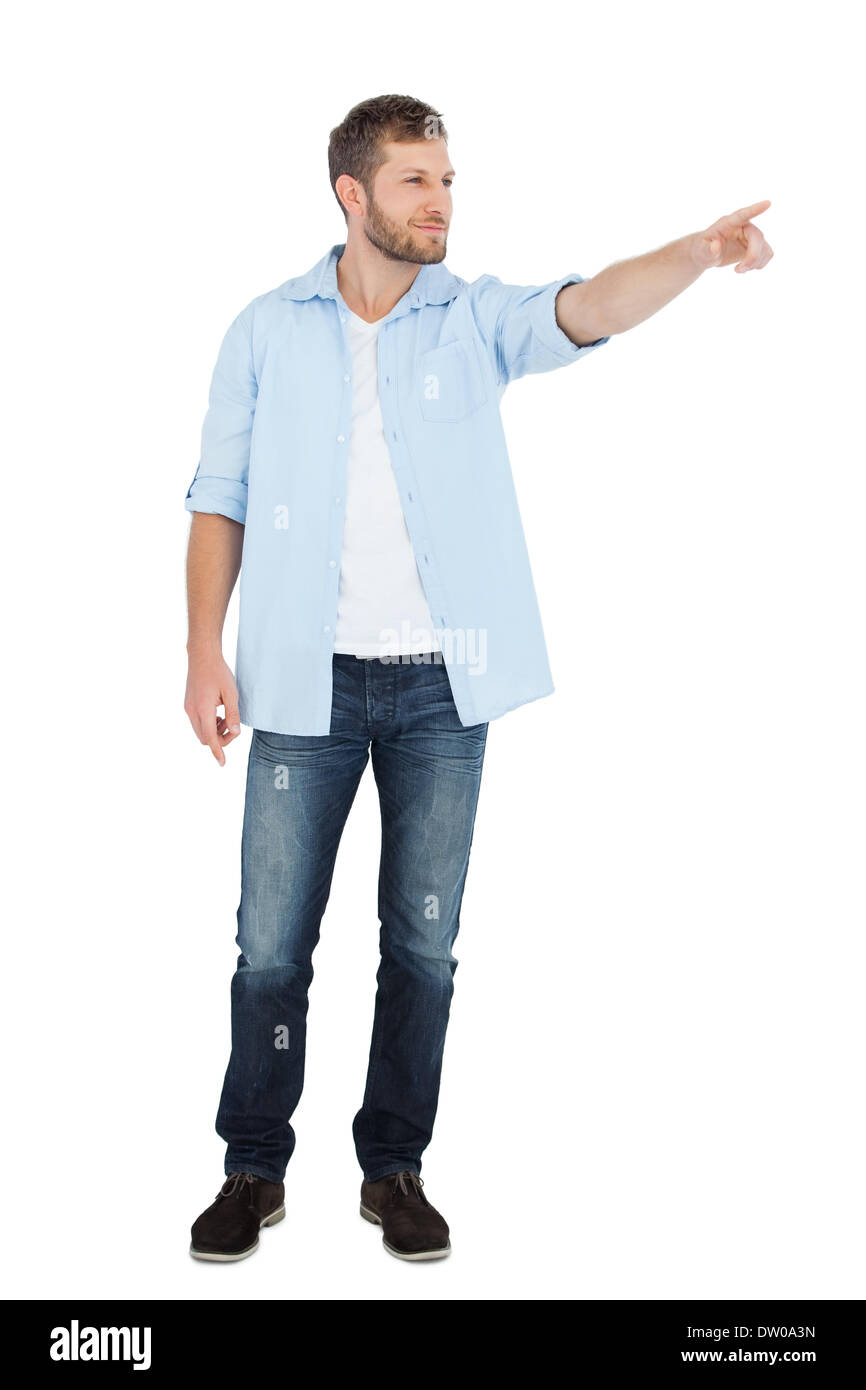 Confident model smiling while pointing Stock Photo - Alamy