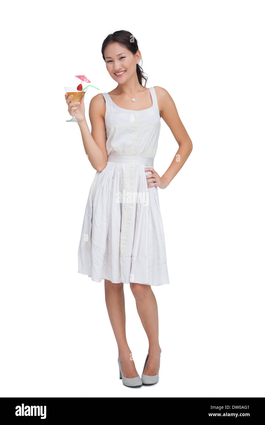 Relaxed brunette posing with cocktail Stock Photo - Alamy