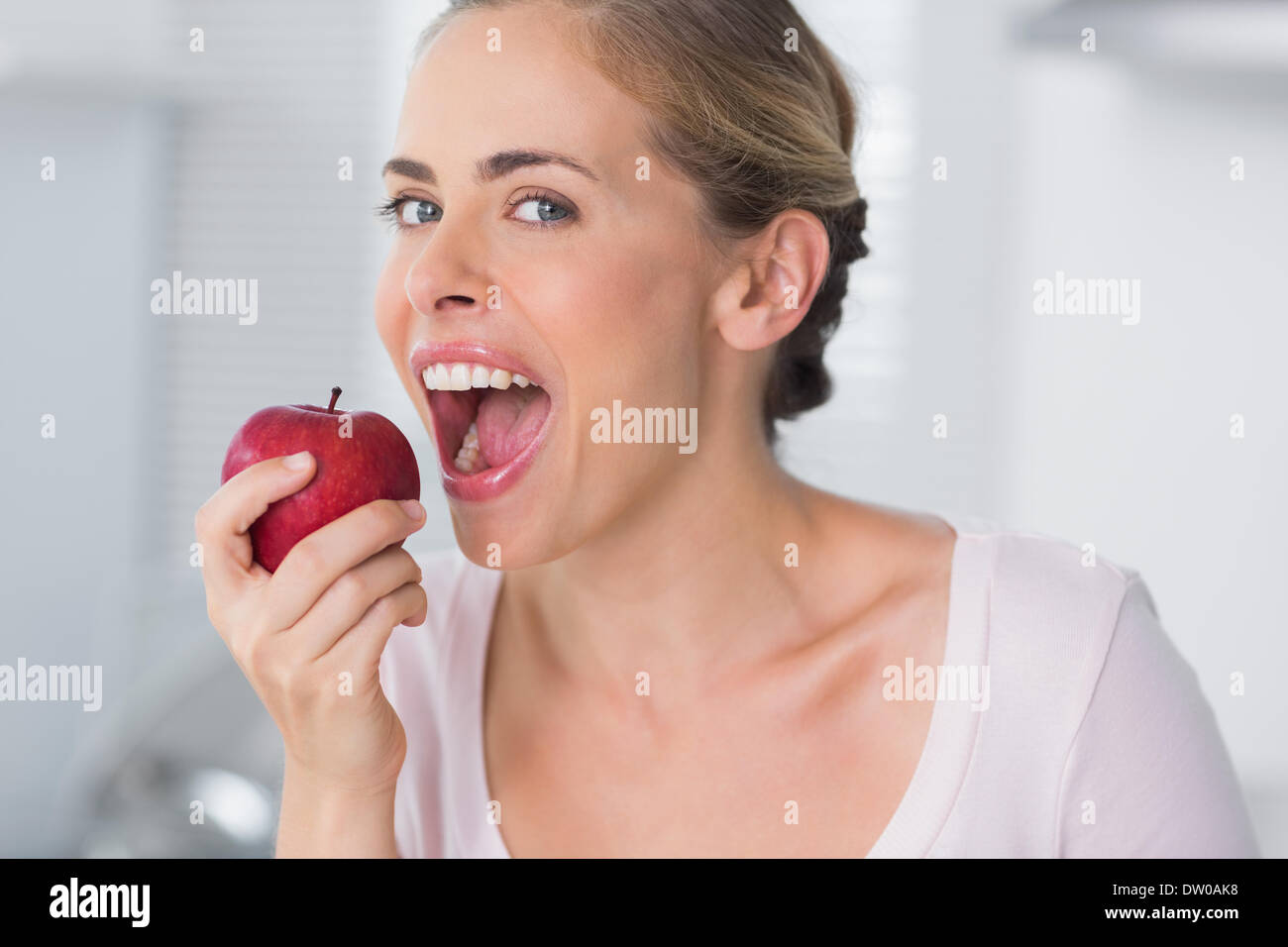 Woman munching apple Stock Photo - Alamy