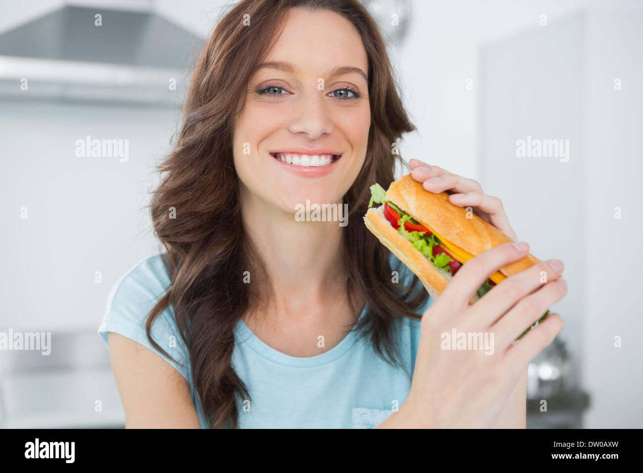 Pretty brunette having sandwich Stock Photo - Alamy