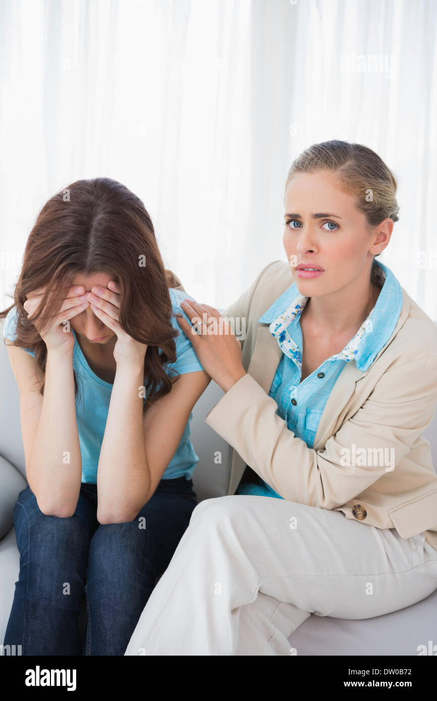 Female psychiatrist comforting young crying hi-res stock photography ...
