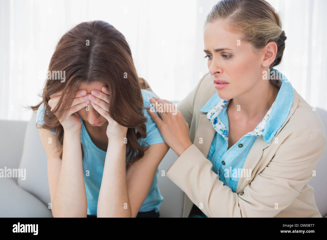 Female psychiatrist comforting young crying hi-res stock photography ...