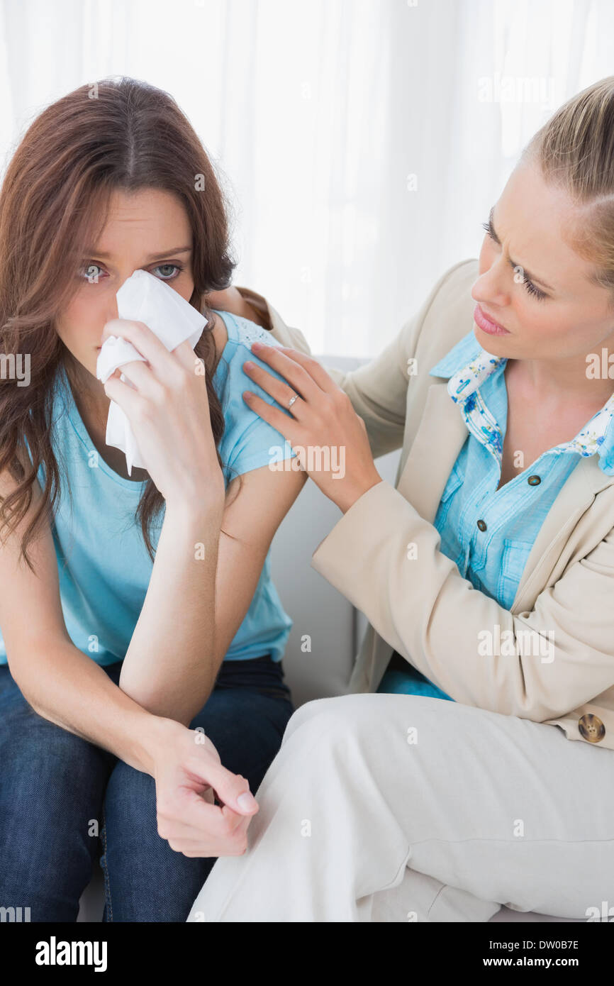 Female psychiatrist comforting young crying hi-res stock photography ...
